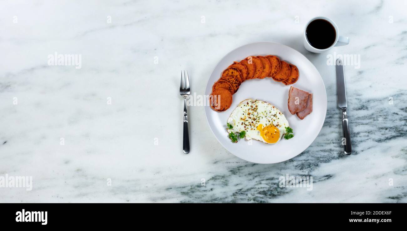 Plate setting of a fresh healthy breakfast and dark coffee for a good ...
