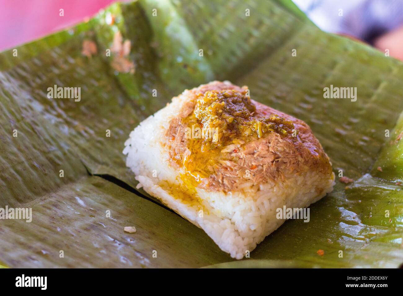 Pater, a local rice dish topped with meat and spicy sauce then wrapped ...
