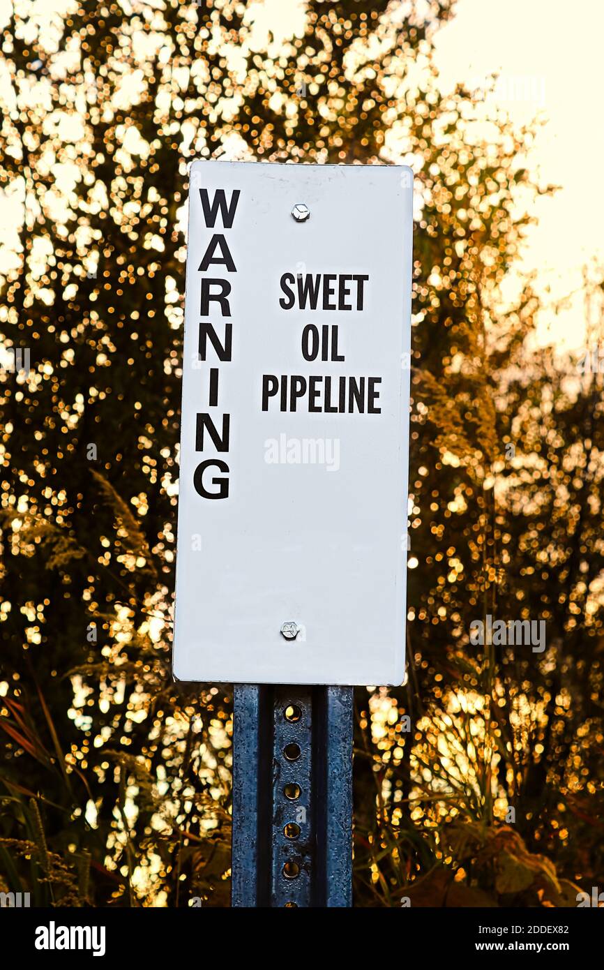 Closeup of a Warning Sweet Oil Pipeline sign Stock Photo - Alamy
