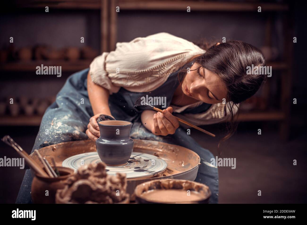 Charming ceramist enjoying pottery art and production process ...