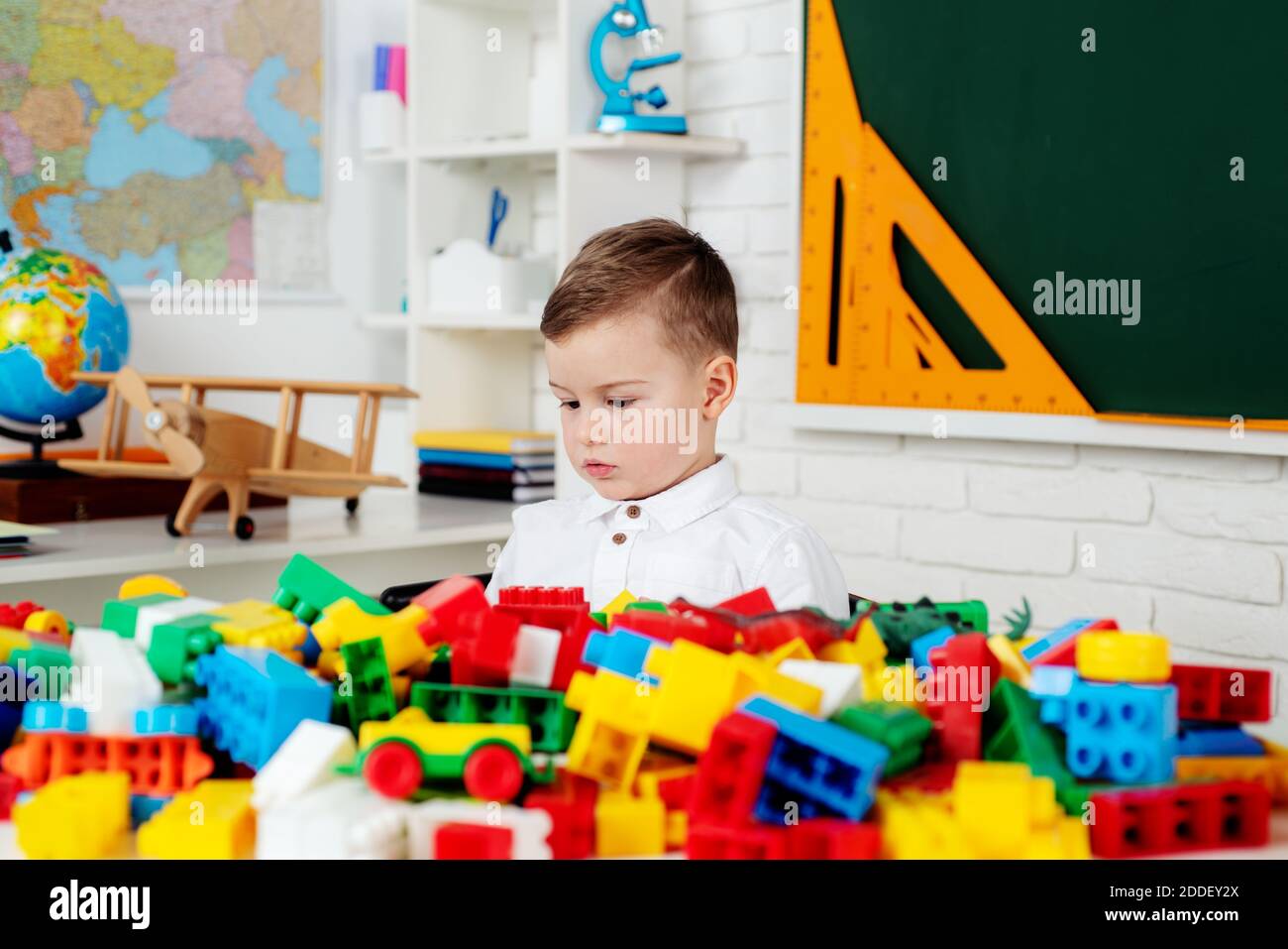 Schoolboy studying homework during her lesson at home. School concept ...