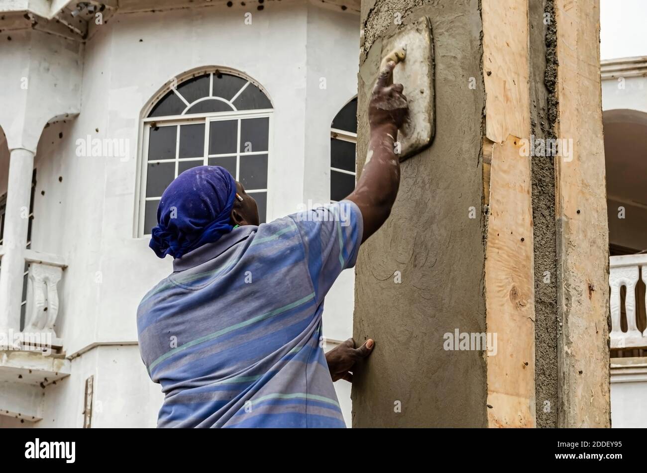 Construction worker using a float to smooth out the cement morter he ...