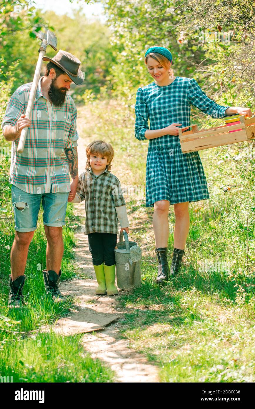 Happy family on farm. Earth day. Beautiful young smiling family having ...