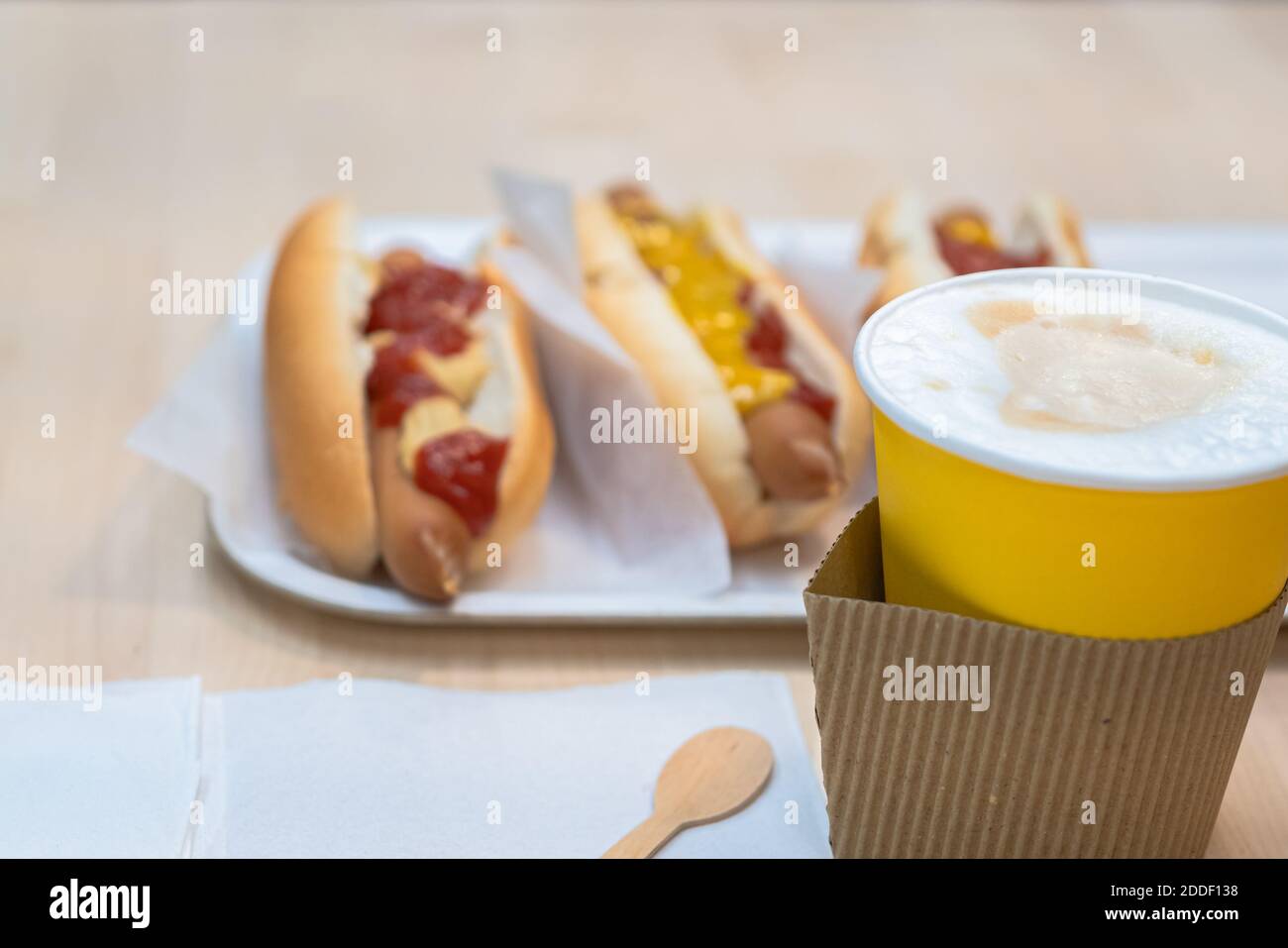Fast food. Coffee in a cup and hot dog with ketchup and sauce. High ...