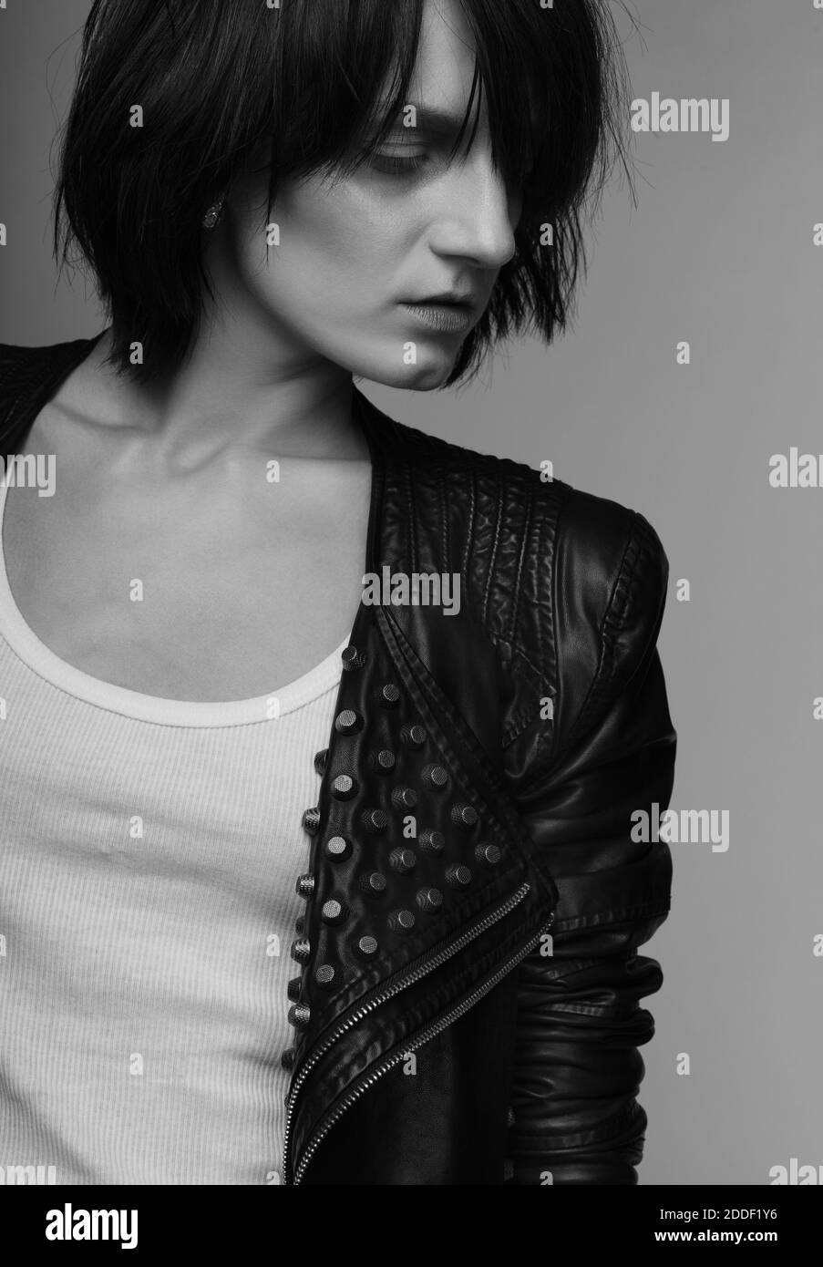 Androgyny female model in Heroin chic style. Old style tinted image ...