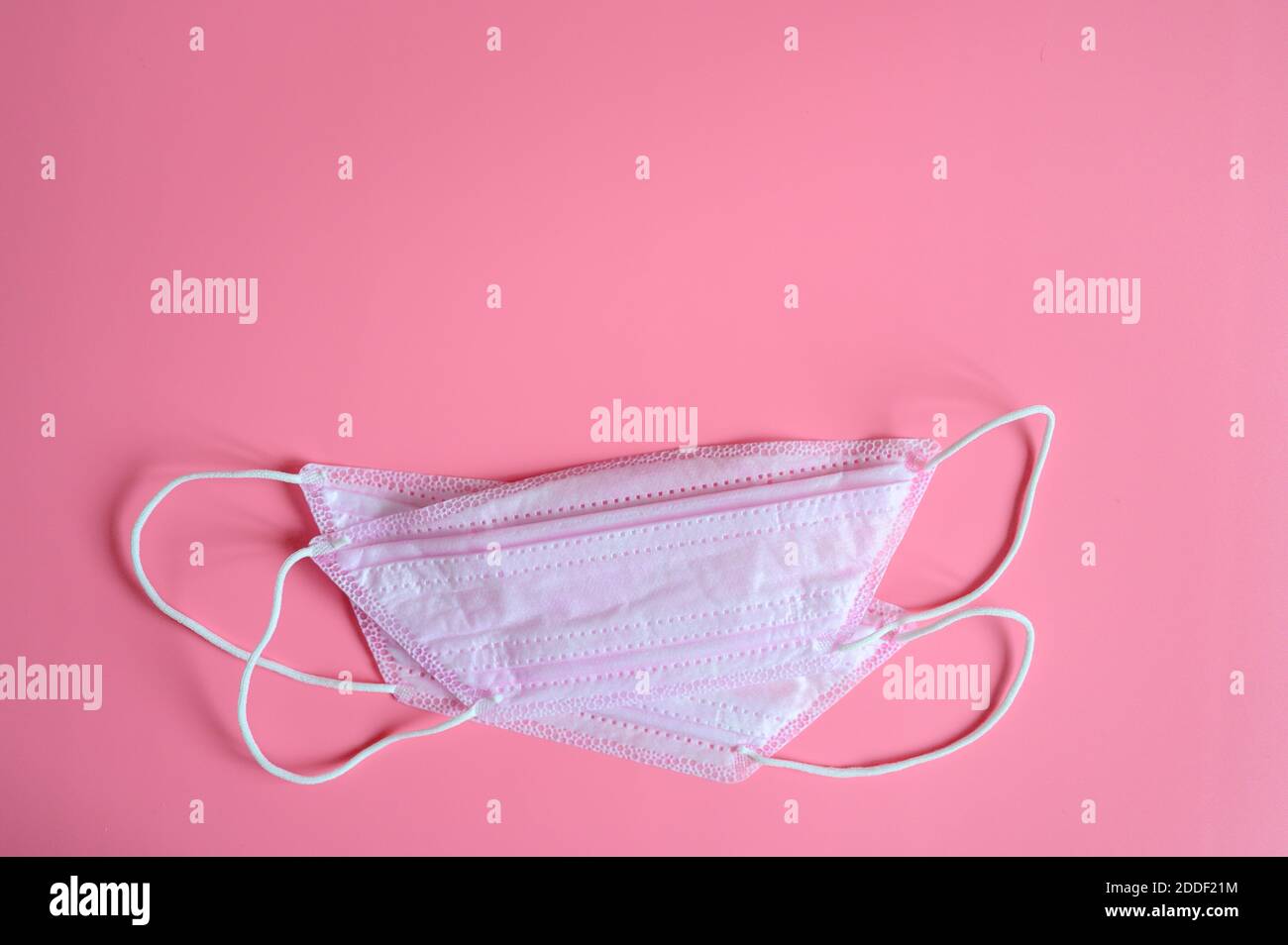 medical masks pink color to cover the mouth and nose for protection ...