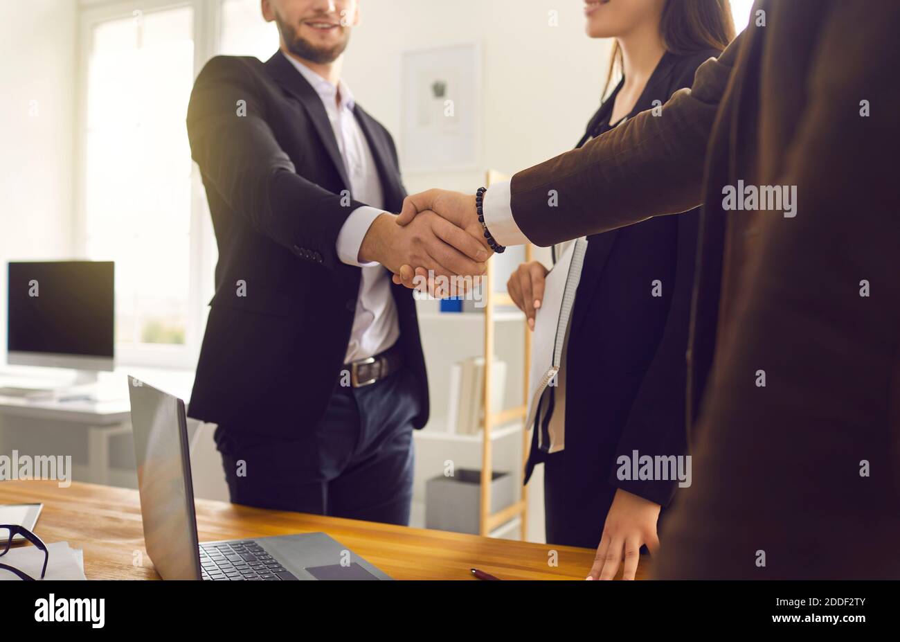 Business partners shaking hands after successful negotiation meeting in ...