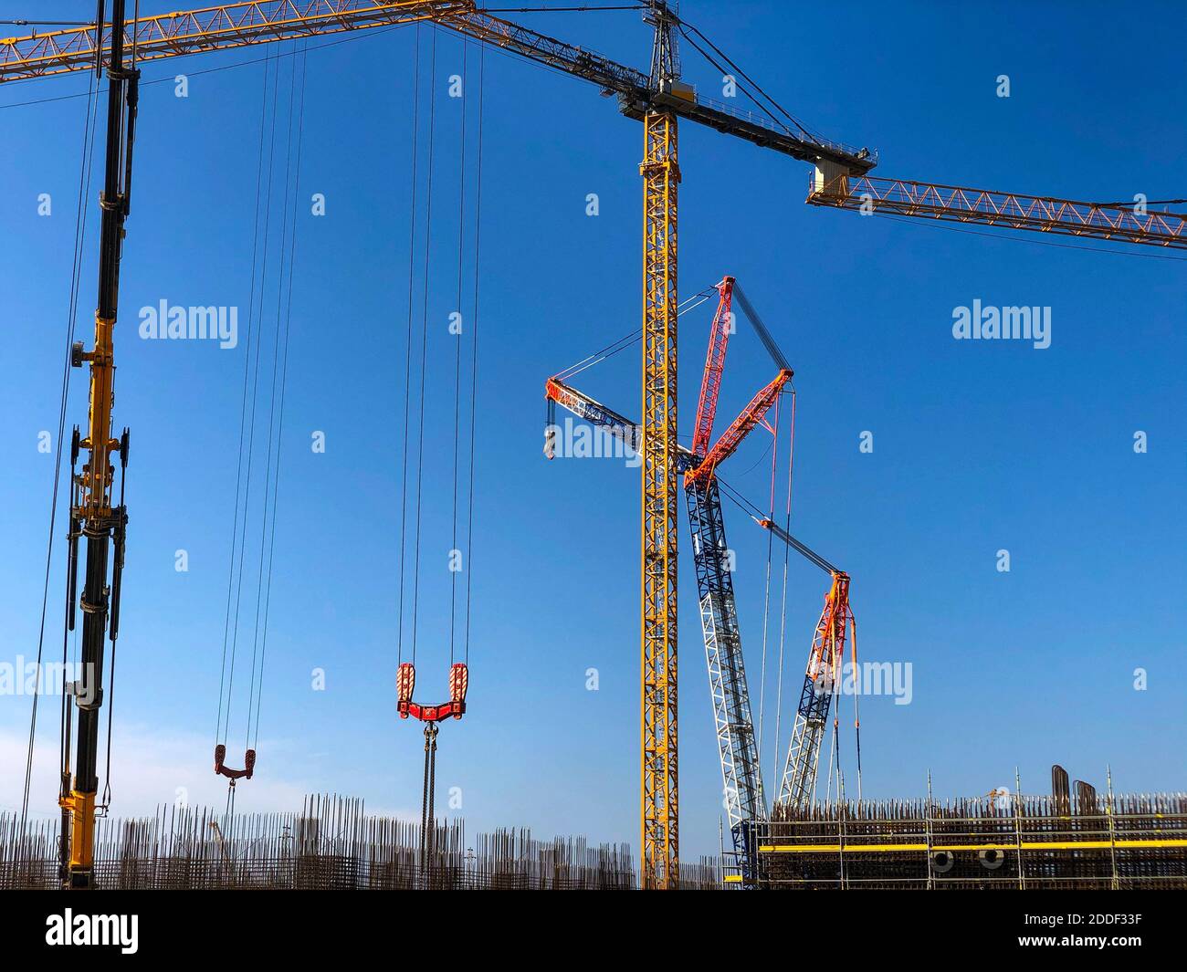 Construction site lots yellow cranes hi-res stock photography and ...