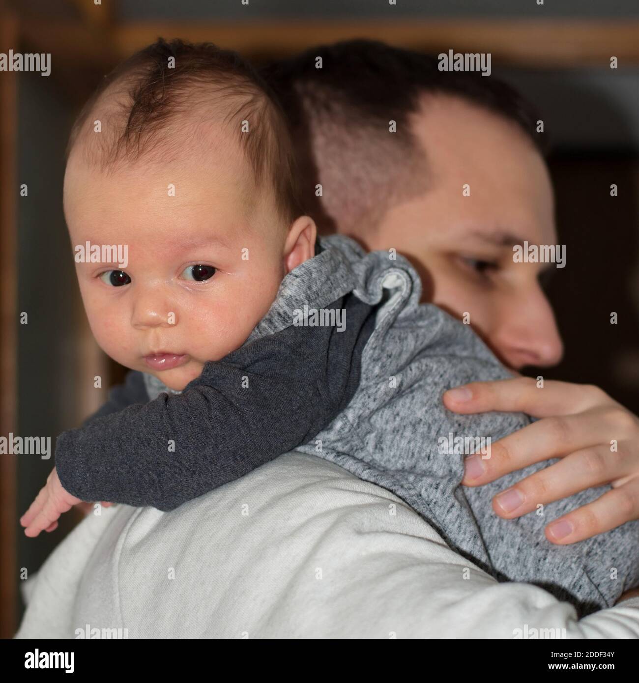 Portrait of man holding newborn baby Stock Photo - Alamy