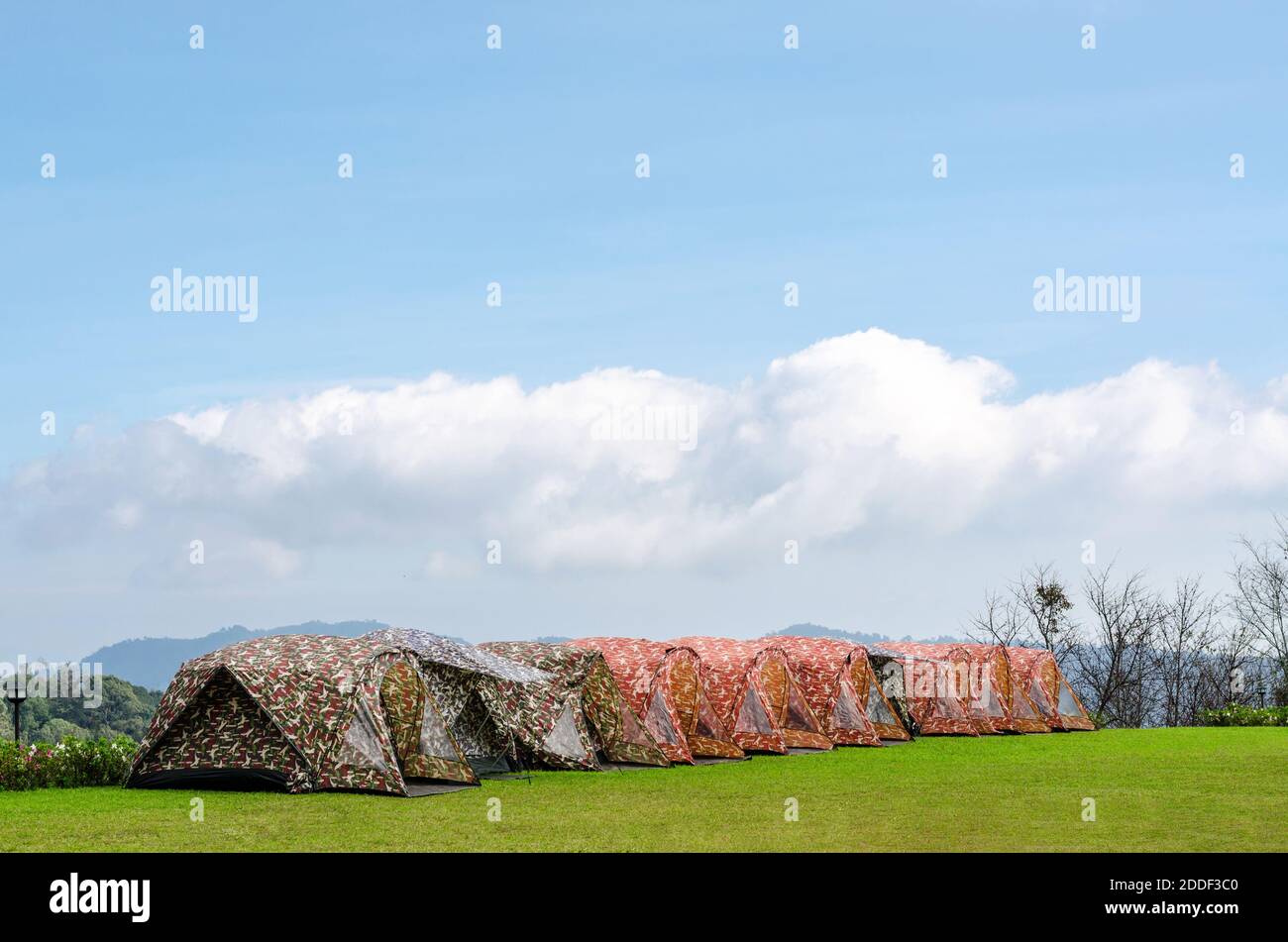 Camouflage tent for the tourist camping on green lawn in park Stock ...