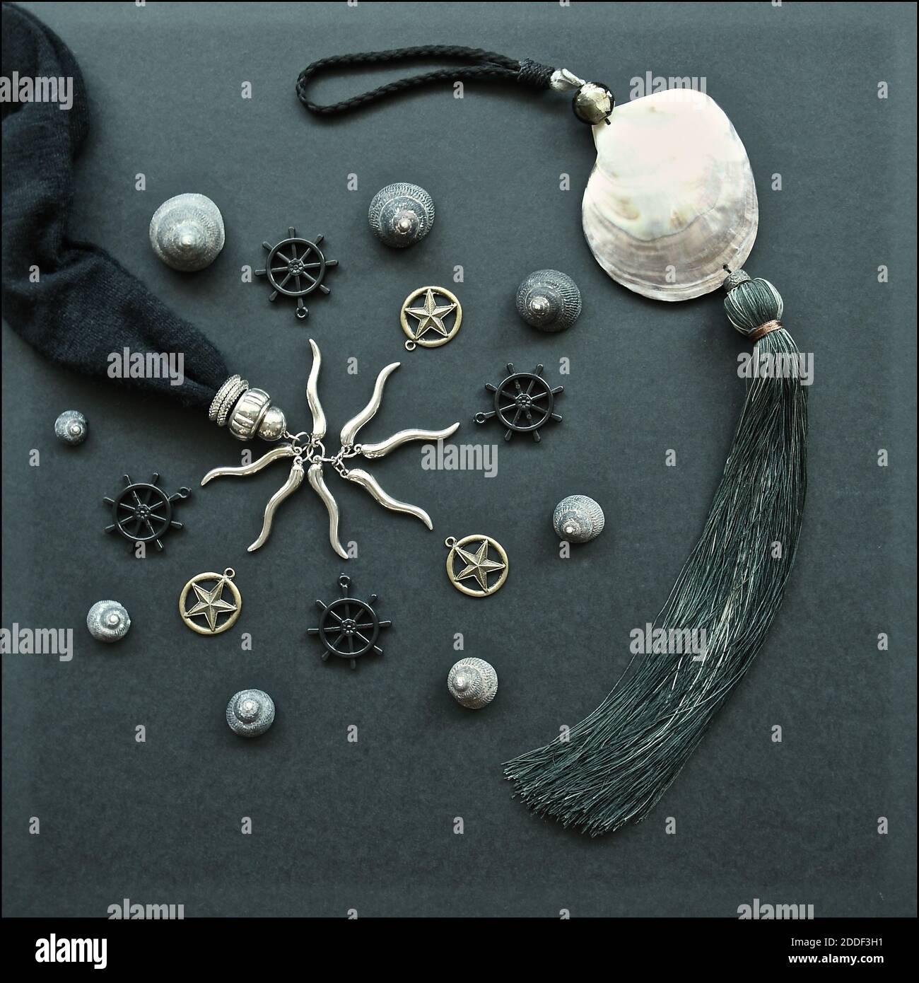 A nautical flat lay on black background with shells, stars and ships ...
