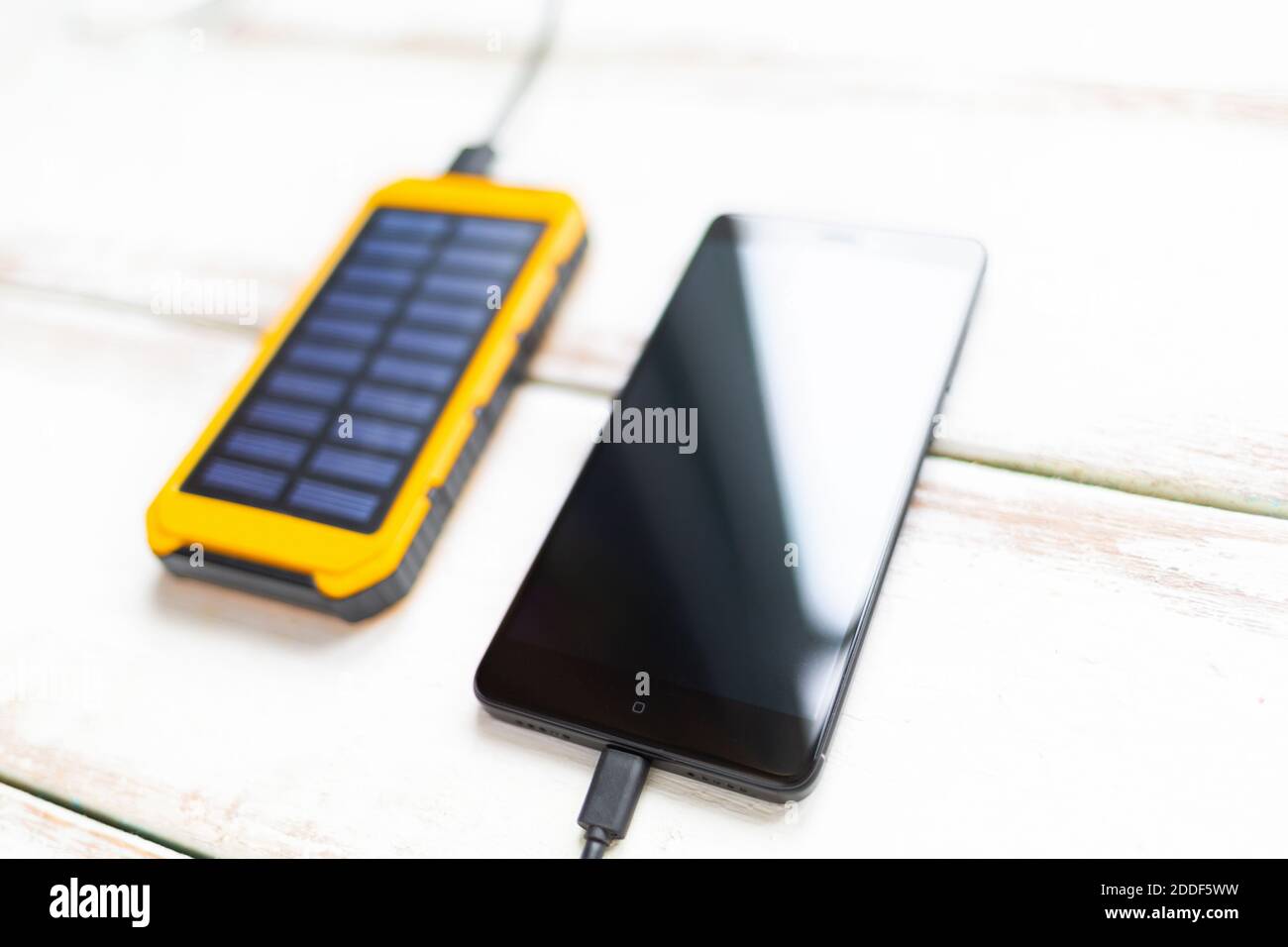 Concept of modern technologies. Smartphone with a black screen, charged ...
