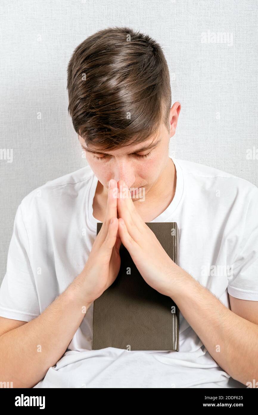 Single man praying hi-res stock photography and images - Alamy