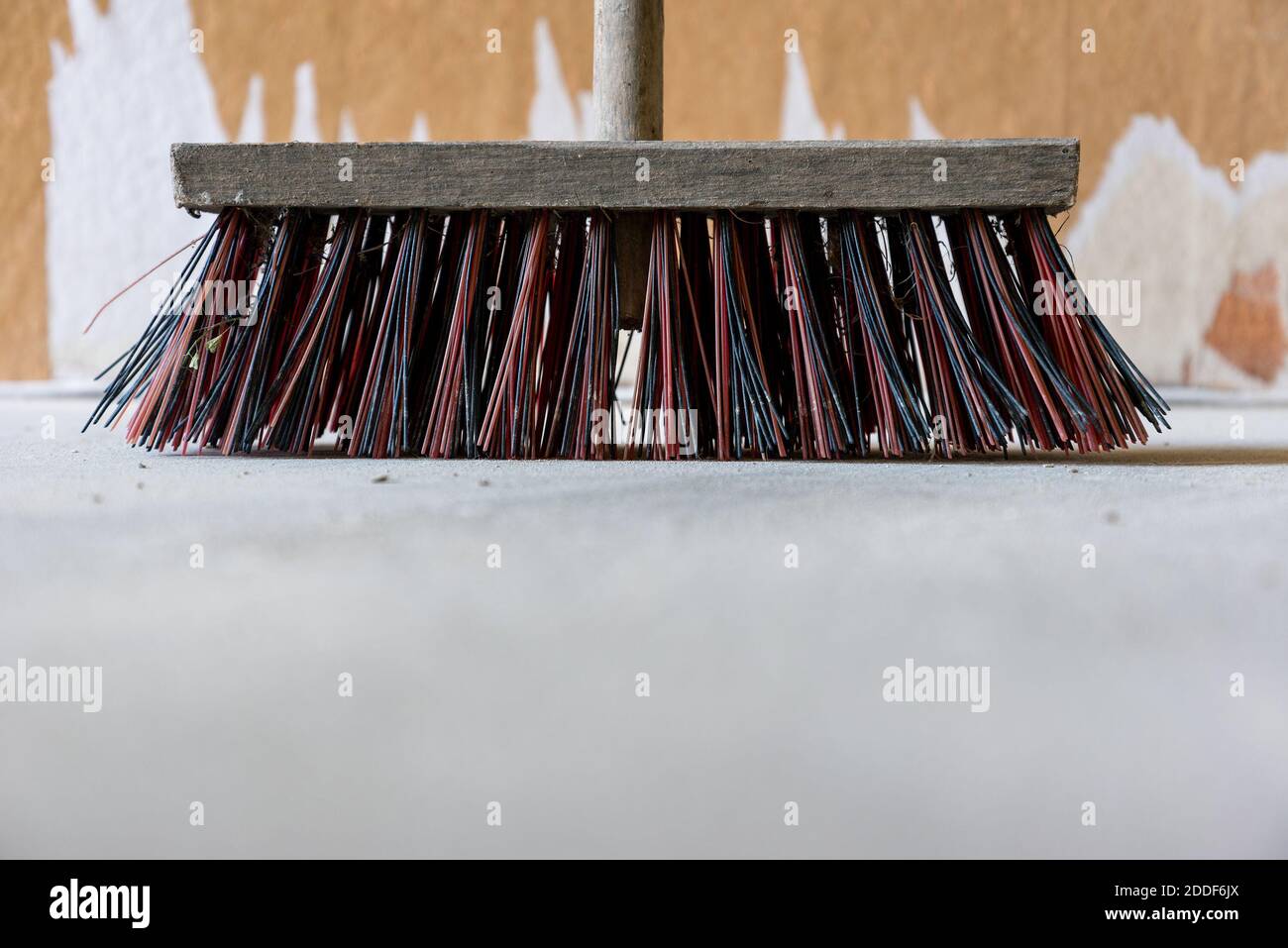 Natural old broom at the wall in house repair time Stock Photo - Alamy