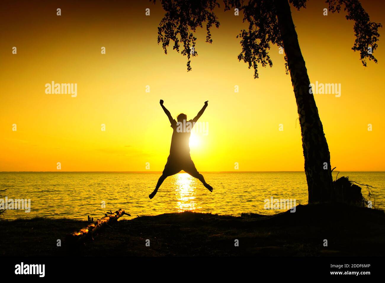 Toned Photo of Happy Person jump on the Sunset Background at Seaside ...