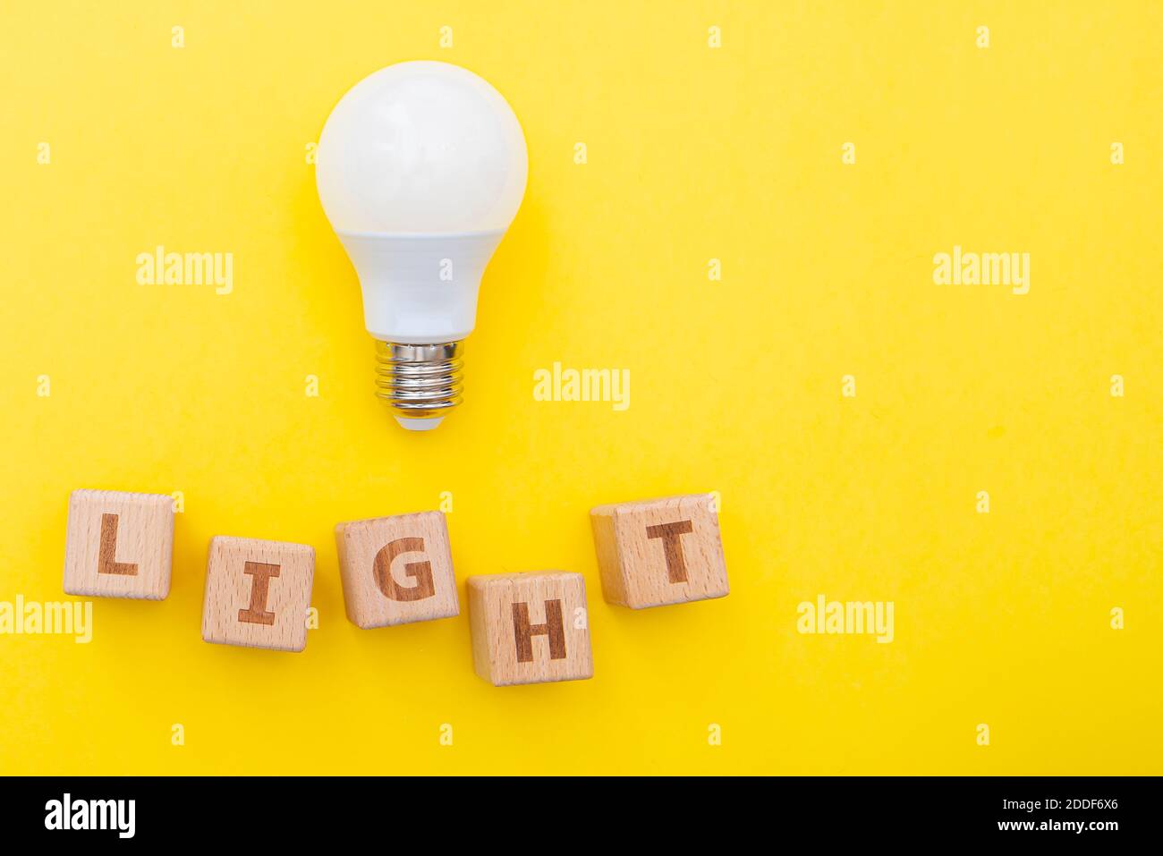 Word Light and light bulb on yellow background, concept picture, layout ...