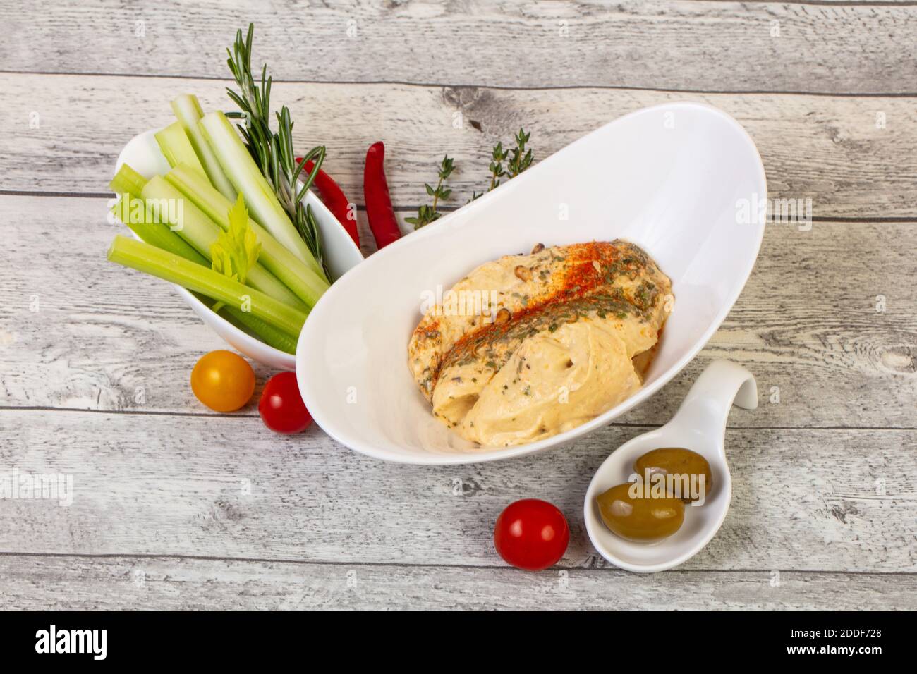 Vegan cuisine - Humus with celery sticks Stock Photo - Alamy
