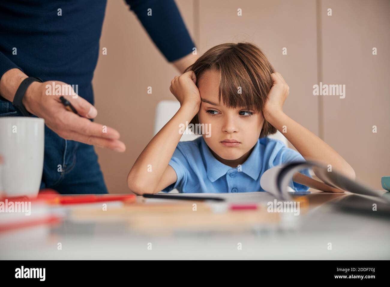 Getting bad mark and hearing disappointed father again Stock Photo - Alamy