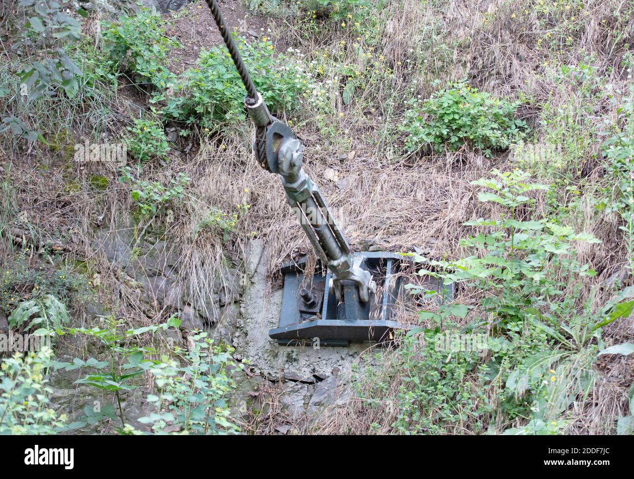 Ground anchor with cable, something strongly attached to the ground ...