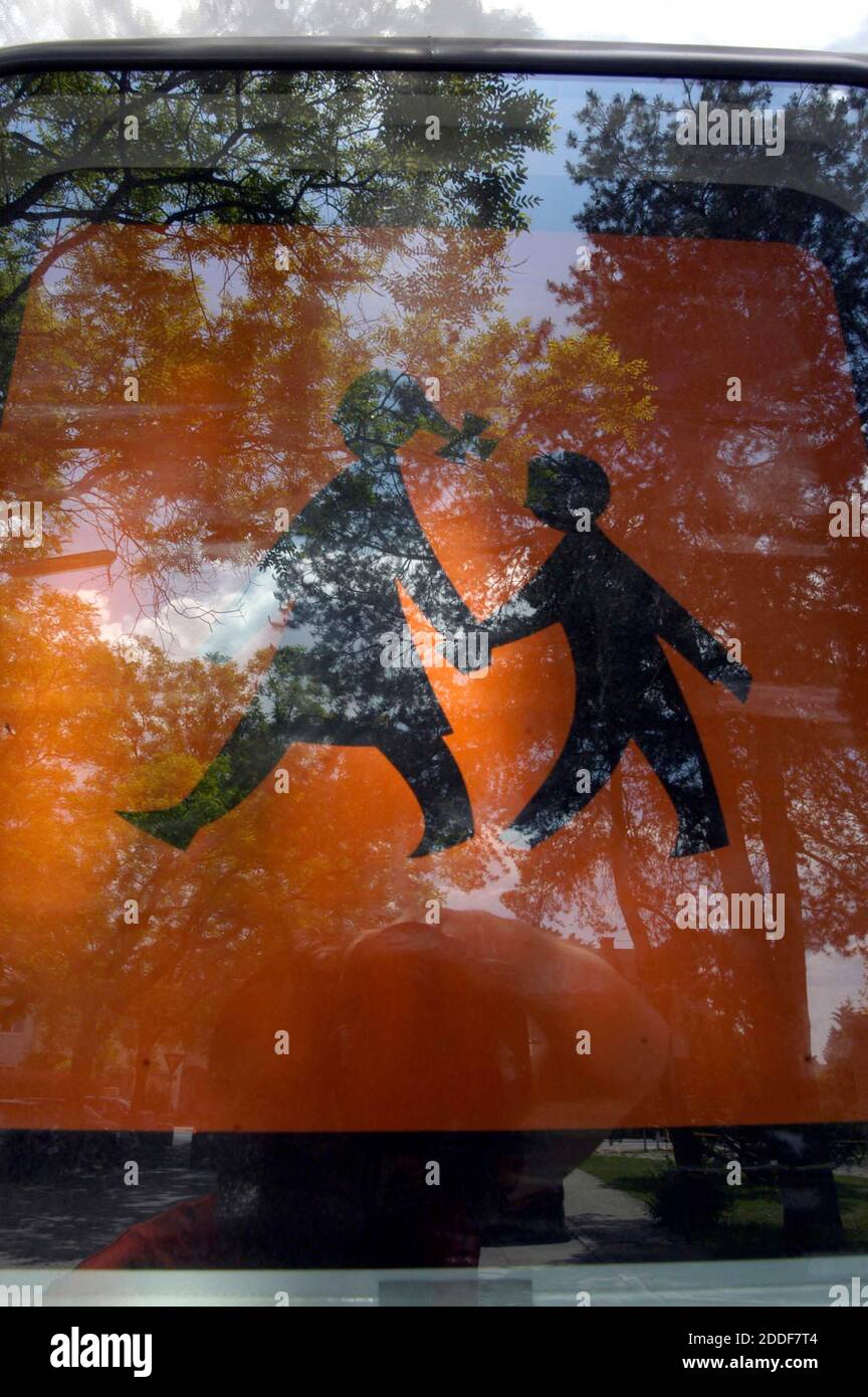 orange children crossing sign at a school bus behind the window Stock ...