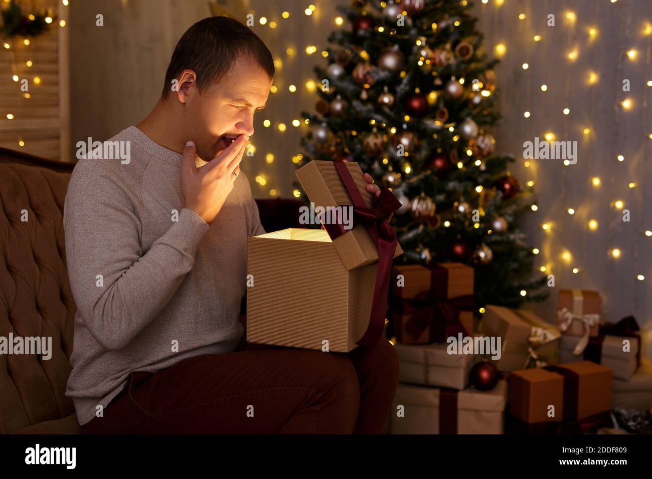 Christmas and magic concept - portrait of surprised young man opening ...