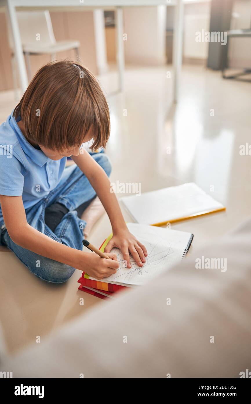 Kid doing his best while learning to write Stock Photo - Alamy