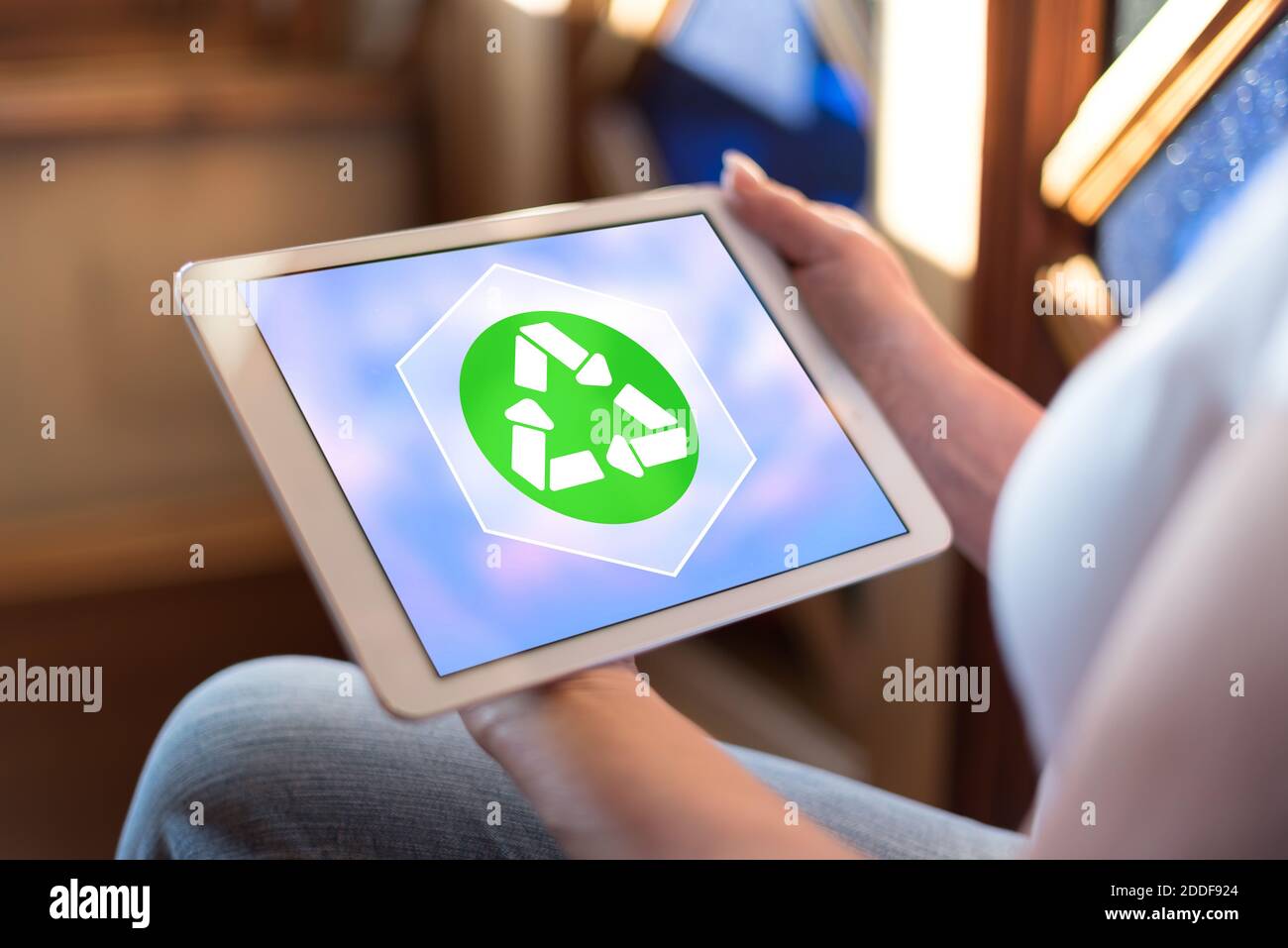 Woman holding a tablet showing recycling concept Stock Photo - Alamy