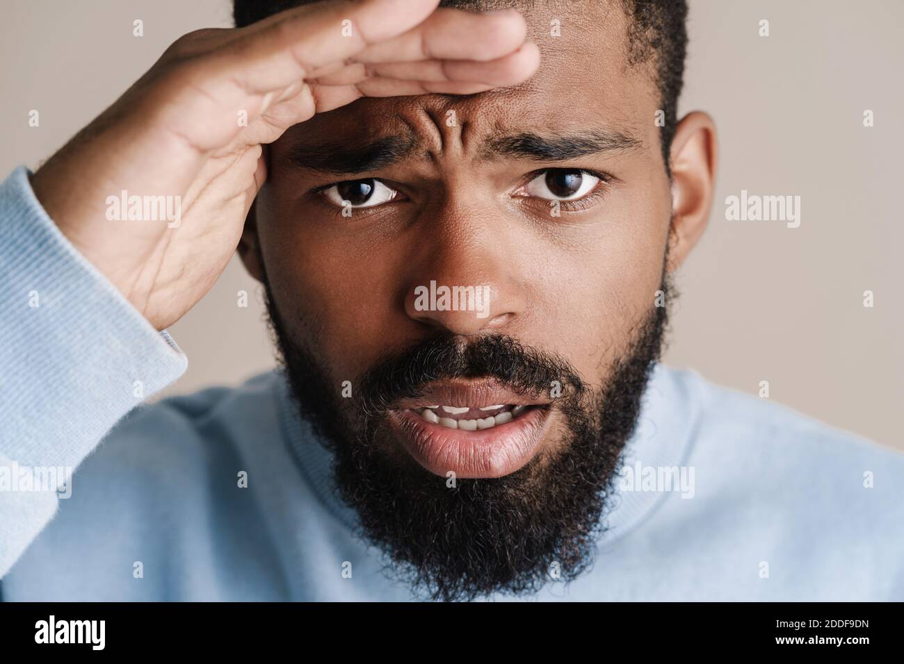 Brooding african american guy posing and looking at camera isolated ...