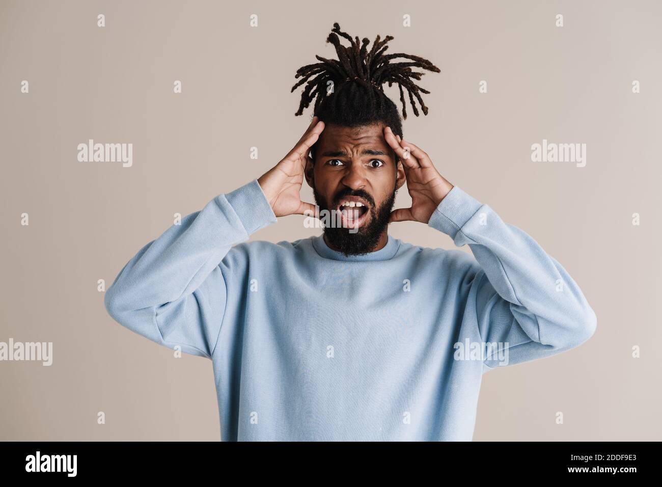 Shocked african american guy screaming and grabbing his head isolated ...