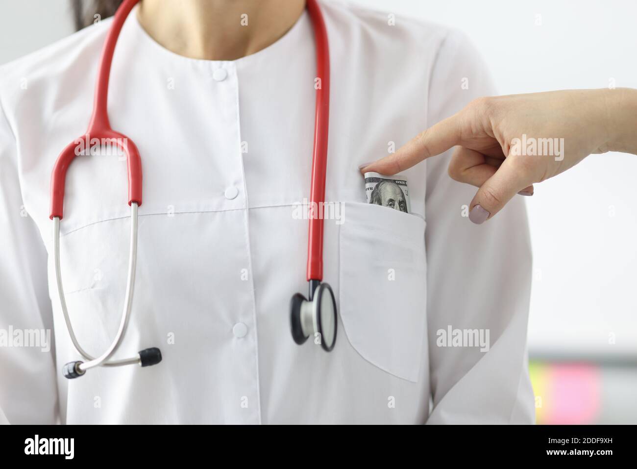 Banknote is thrust into doctor's pocket closeup Stock Photo - Alamy