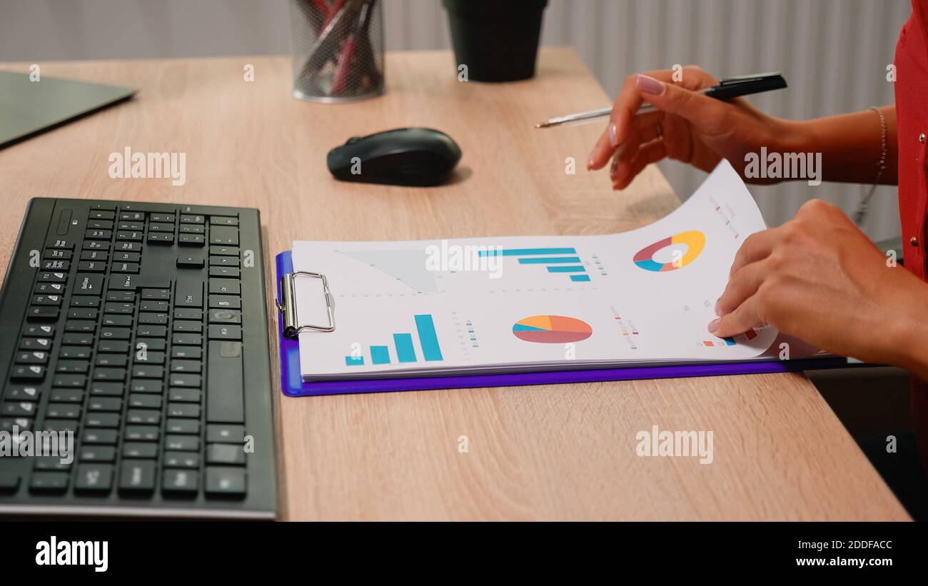 Close up of woman typing on keyboard sitting at desk and reading on ...