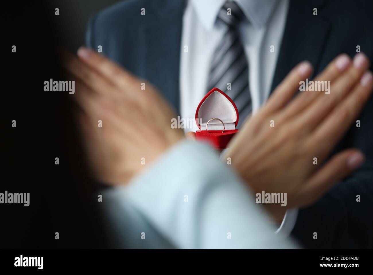 Man is holding wedding ring. Woman is making negative gesture Stock ...
