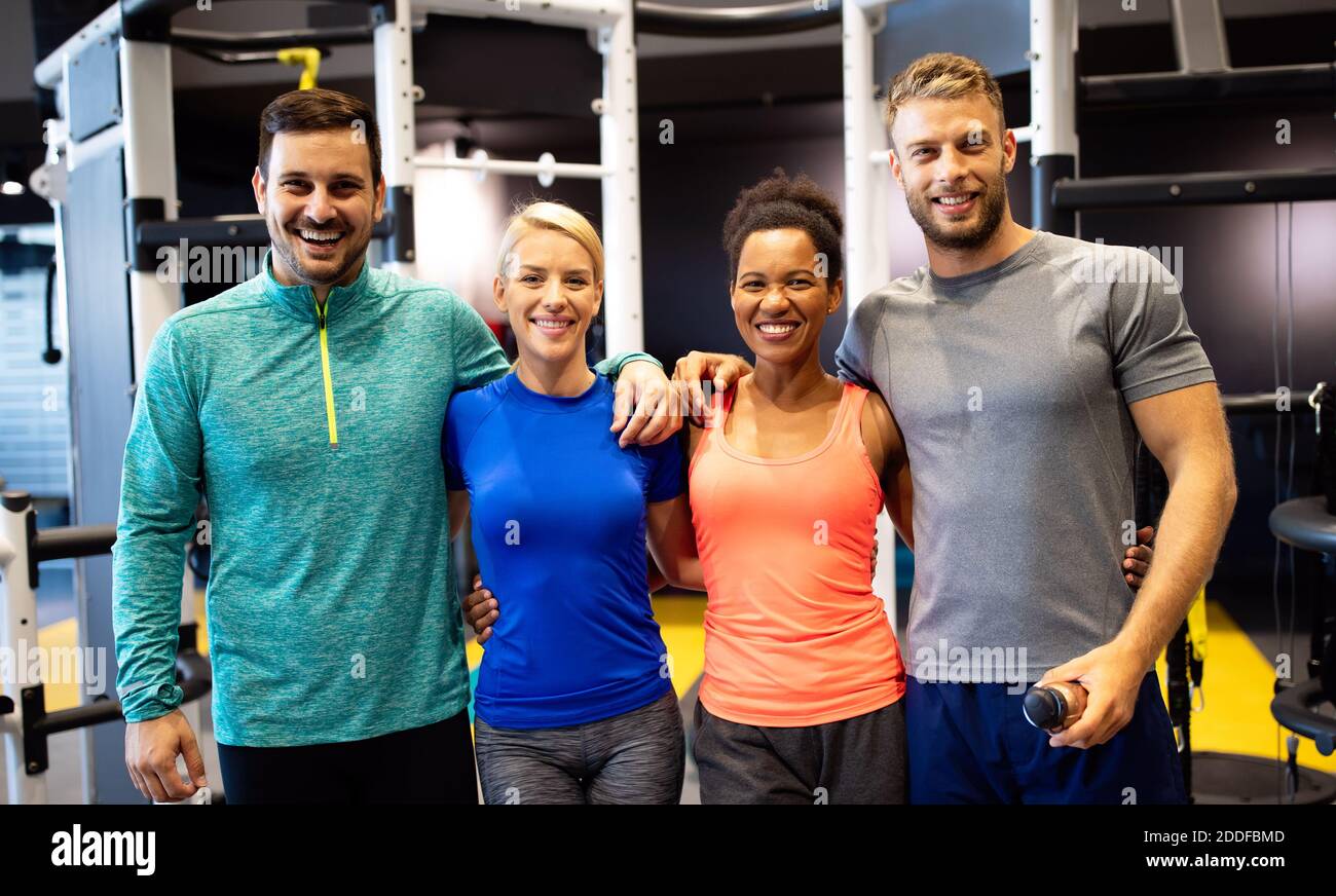 Group of sportive people in gym. Happy fit friends workout, exercise in ...