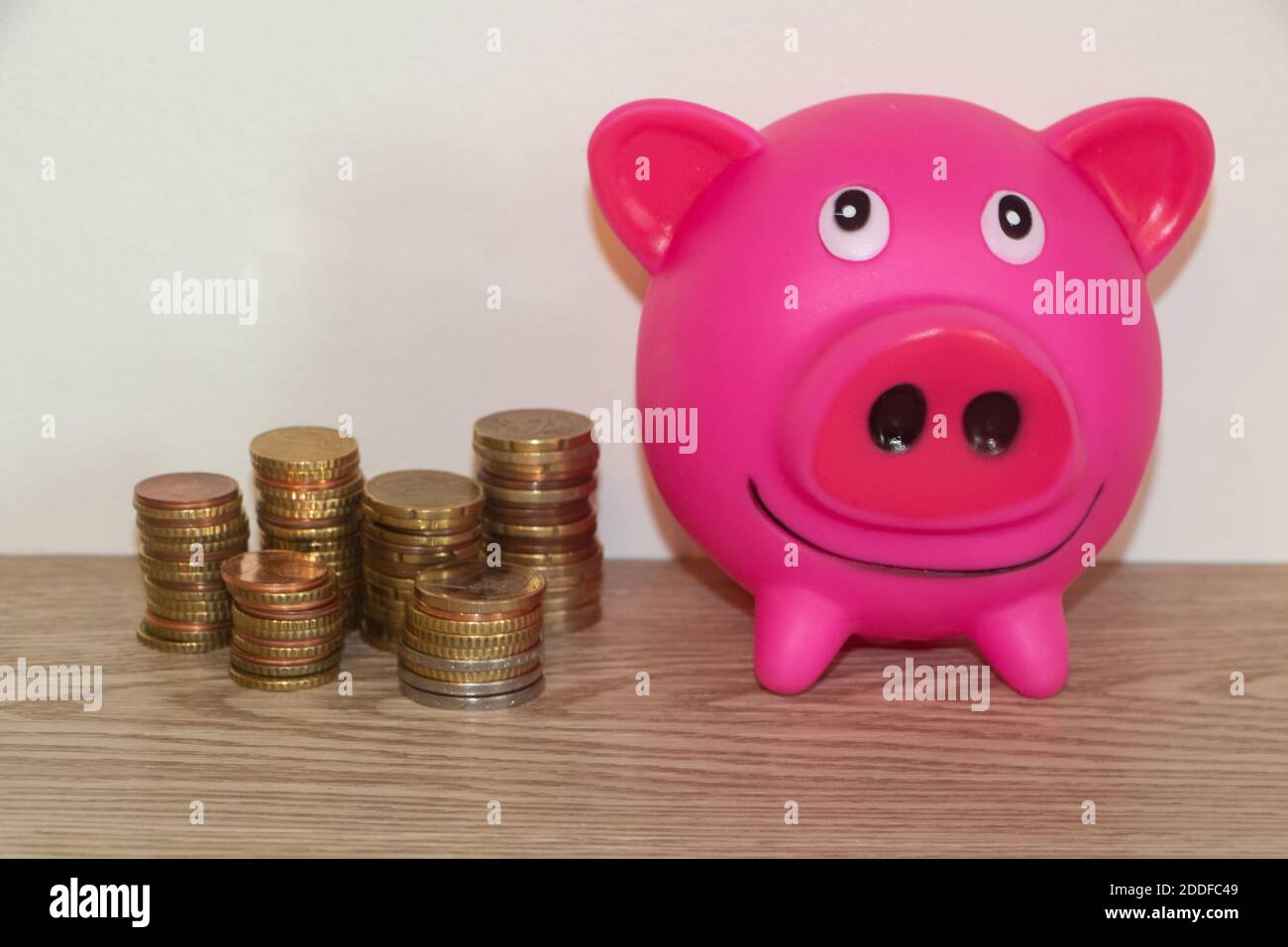 Piggy bank and heap of euros coins Stock Photo - Alamy