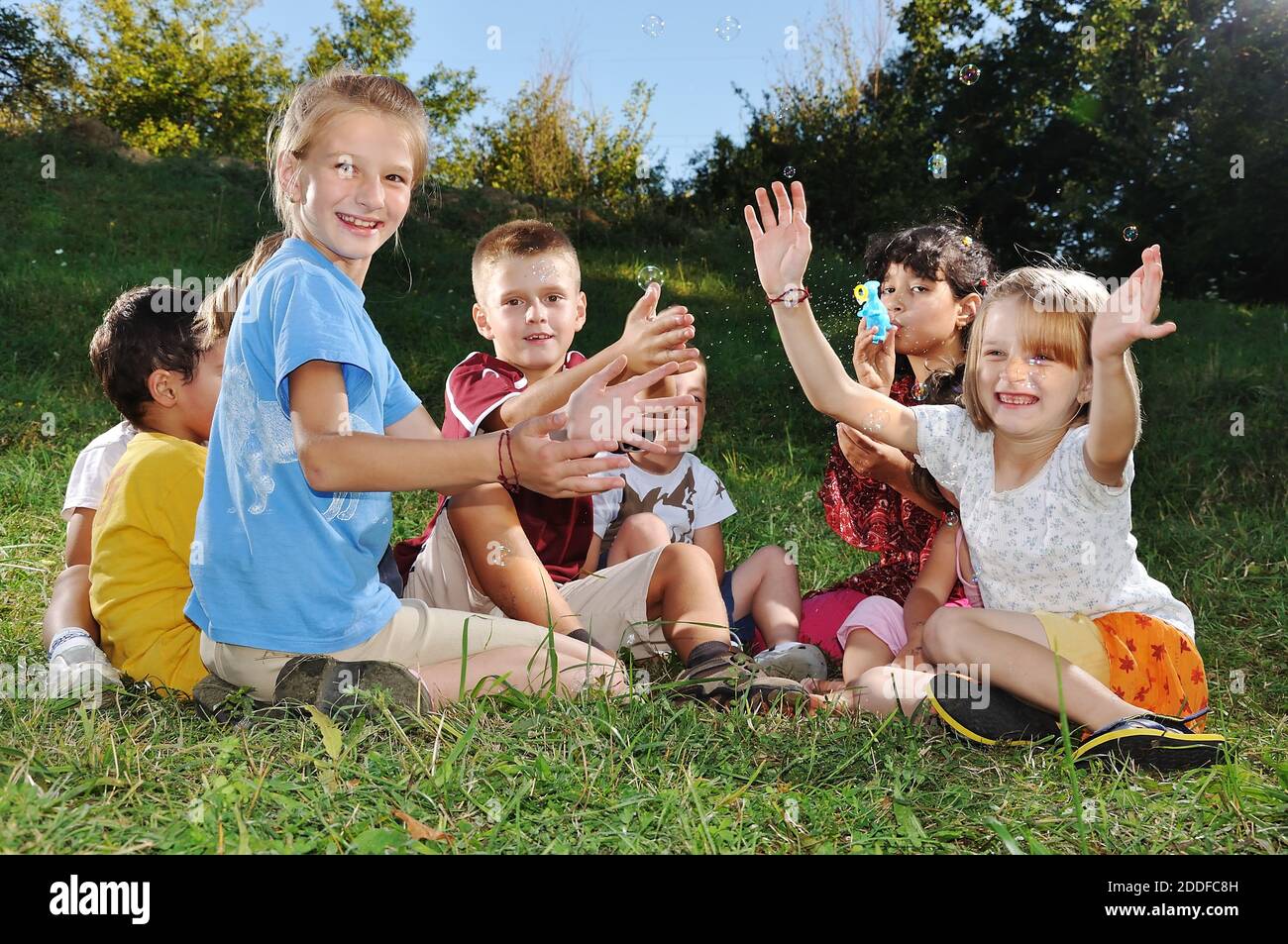 Happy beautiful children playing on ground outdoor Stock Photo - Alamy