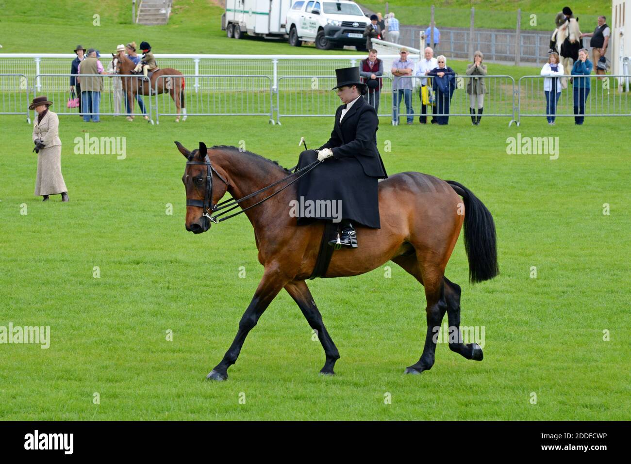 Women riding side saddle in a competition at the Royal Welsh spring ...