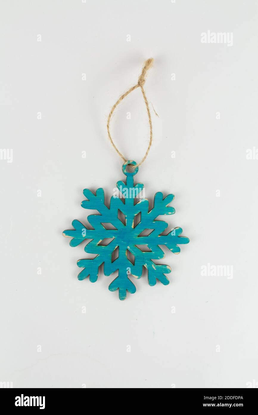 a wooden snowflake for christmas tree on white Stock Photo - Alamy