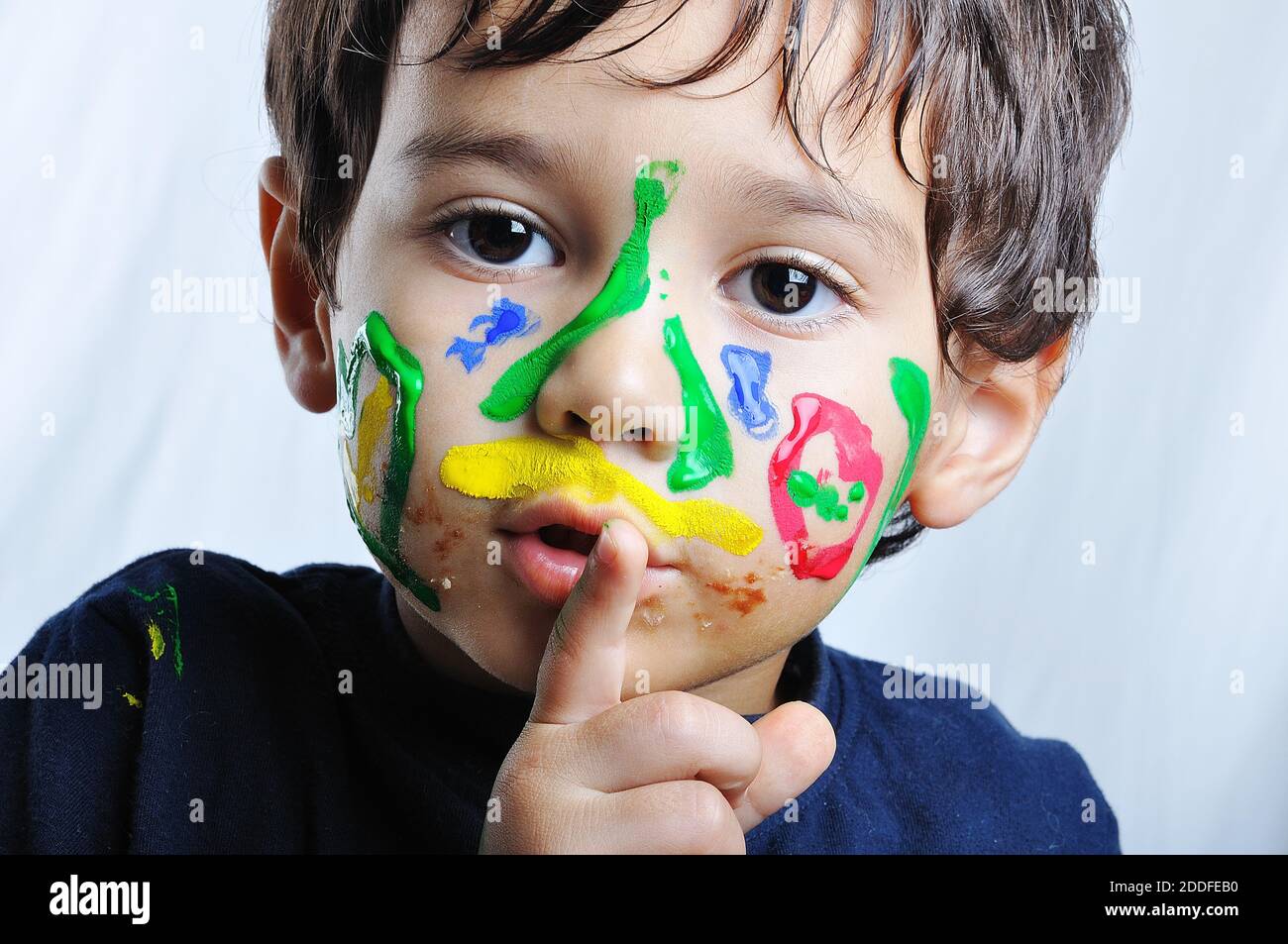 A little cute child with several colors on white Stock Photo - Alamy