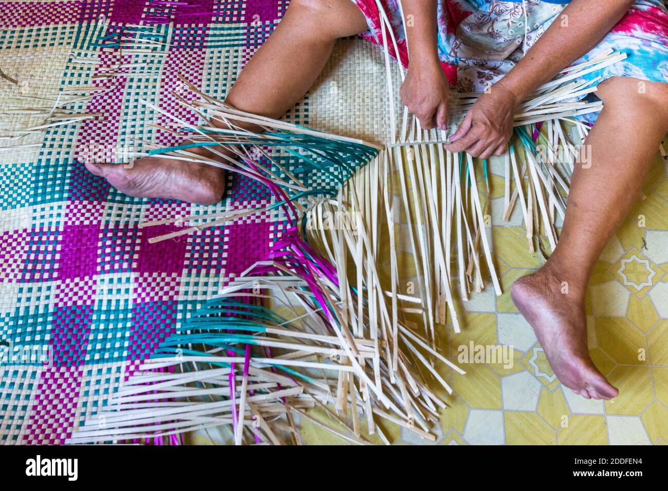 A mat weaver making a colorful piece in Biliran, Philippines Stock ...