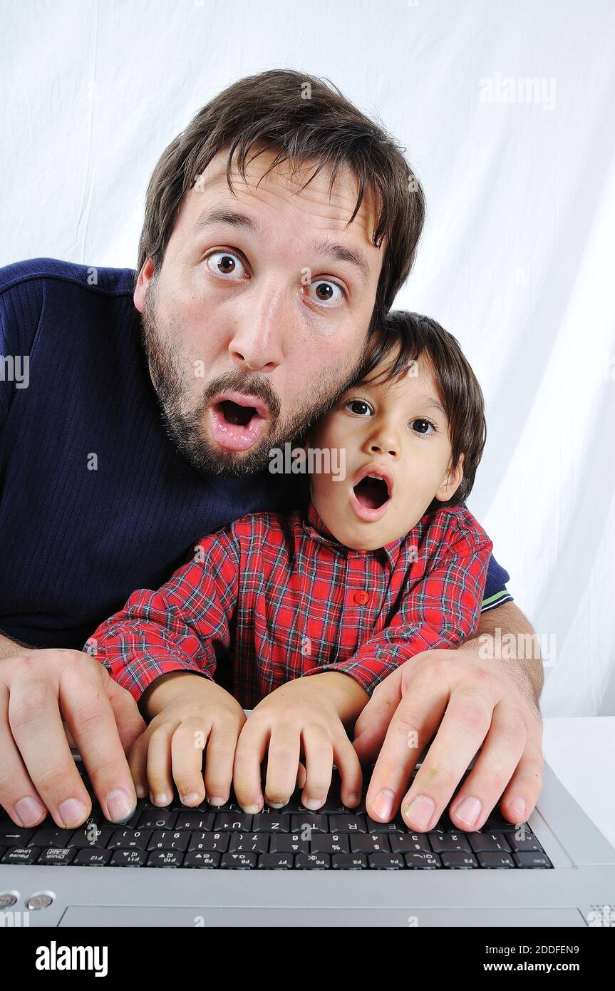 A little cute kid with a laptop isolated, shocked face Stock Photo - Alamy