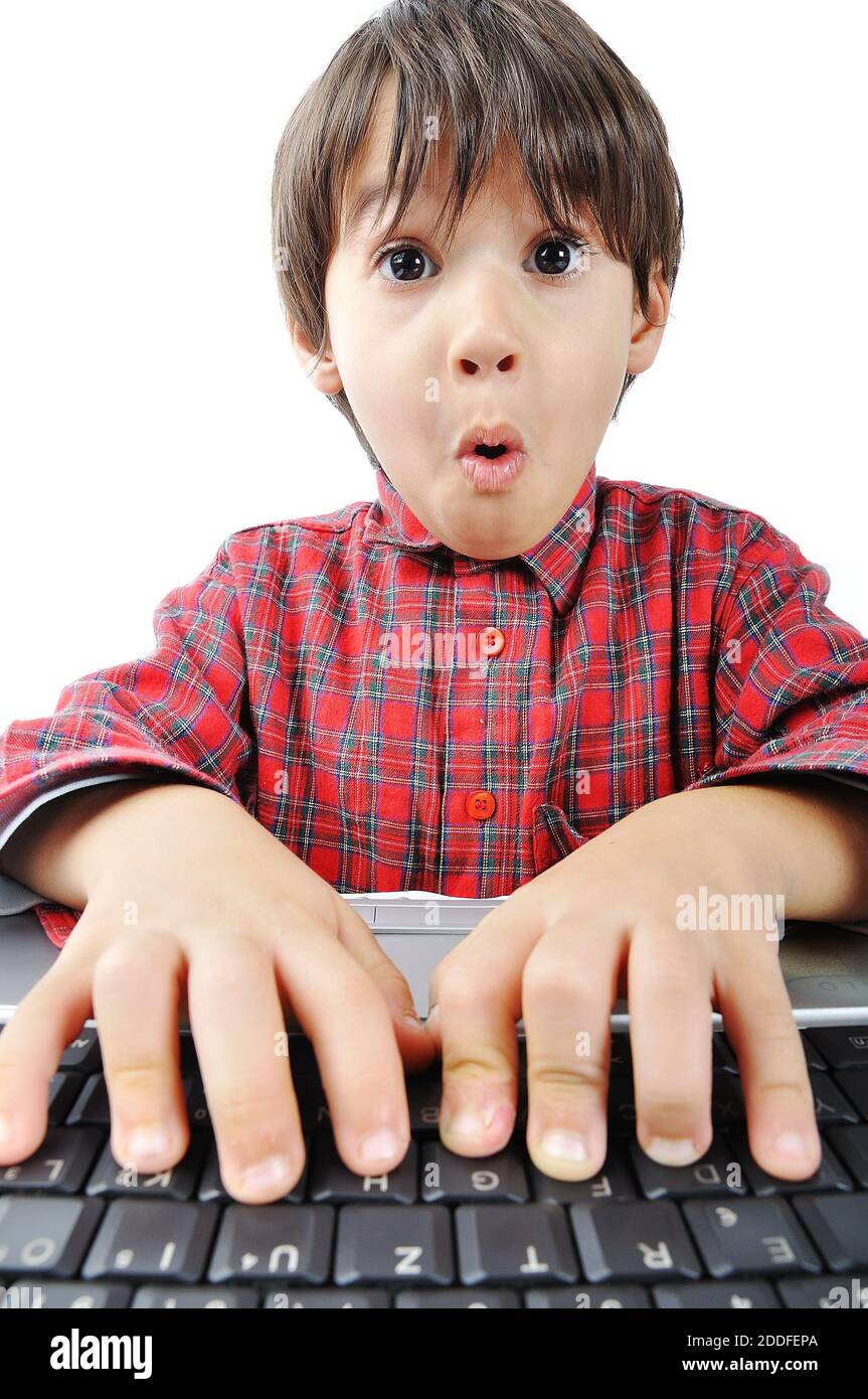 A little cute kid with a laptop isolated, shocked face Stock Photo - Alamy