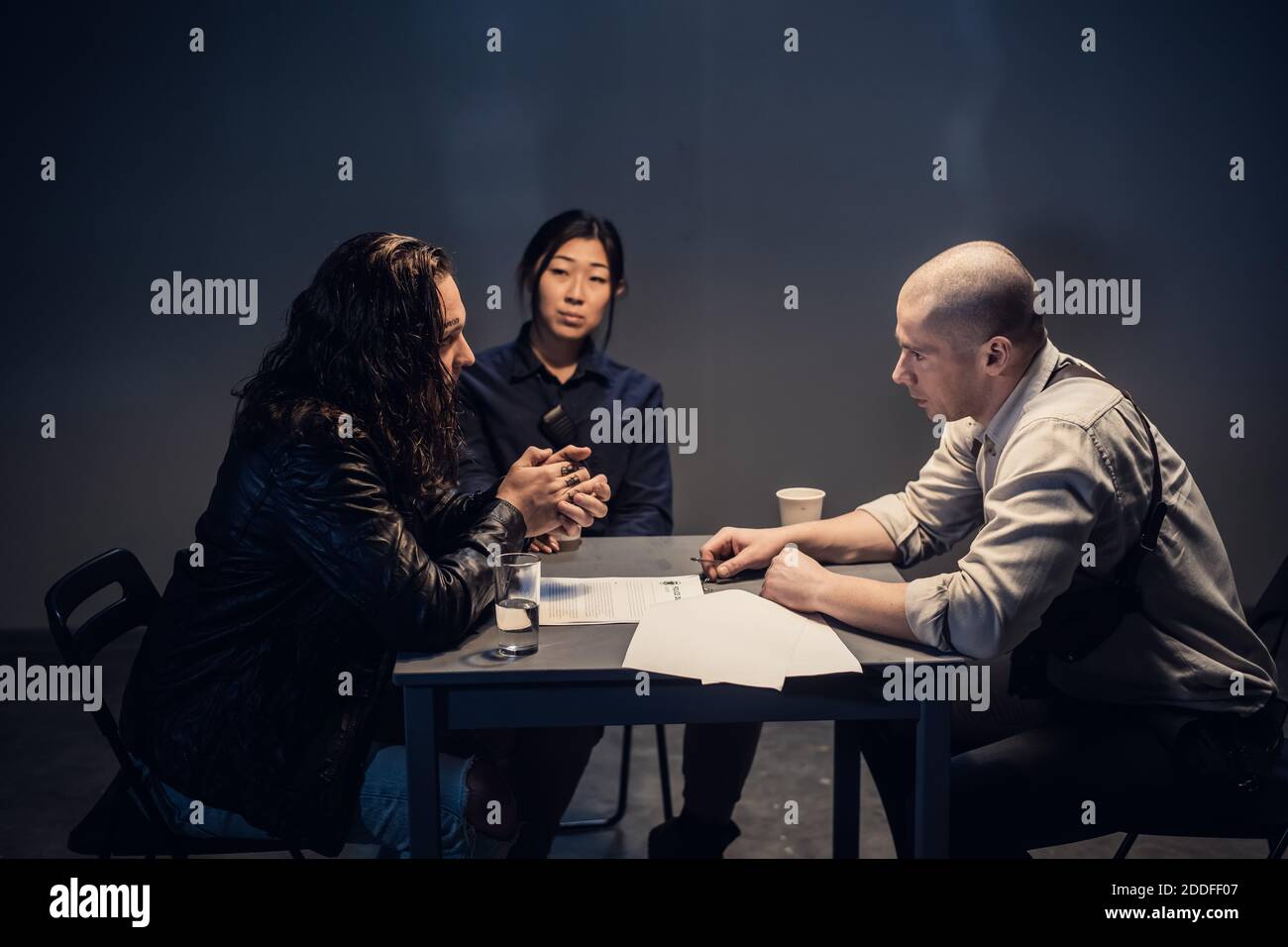 A police detective at the station and his partner, an asian woman ...