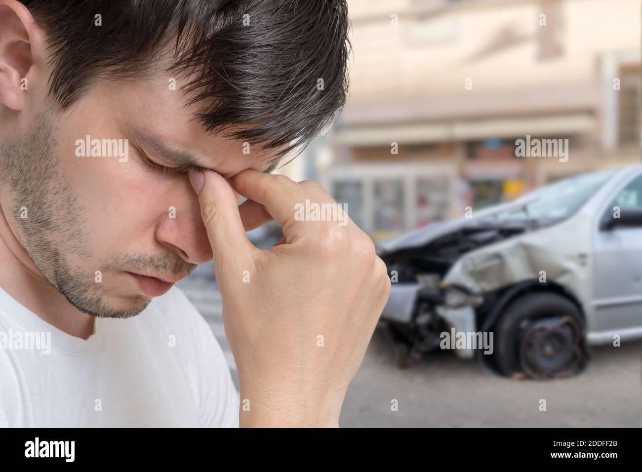 Young sad man had car accident. Damaged car in background Stock Photo ...