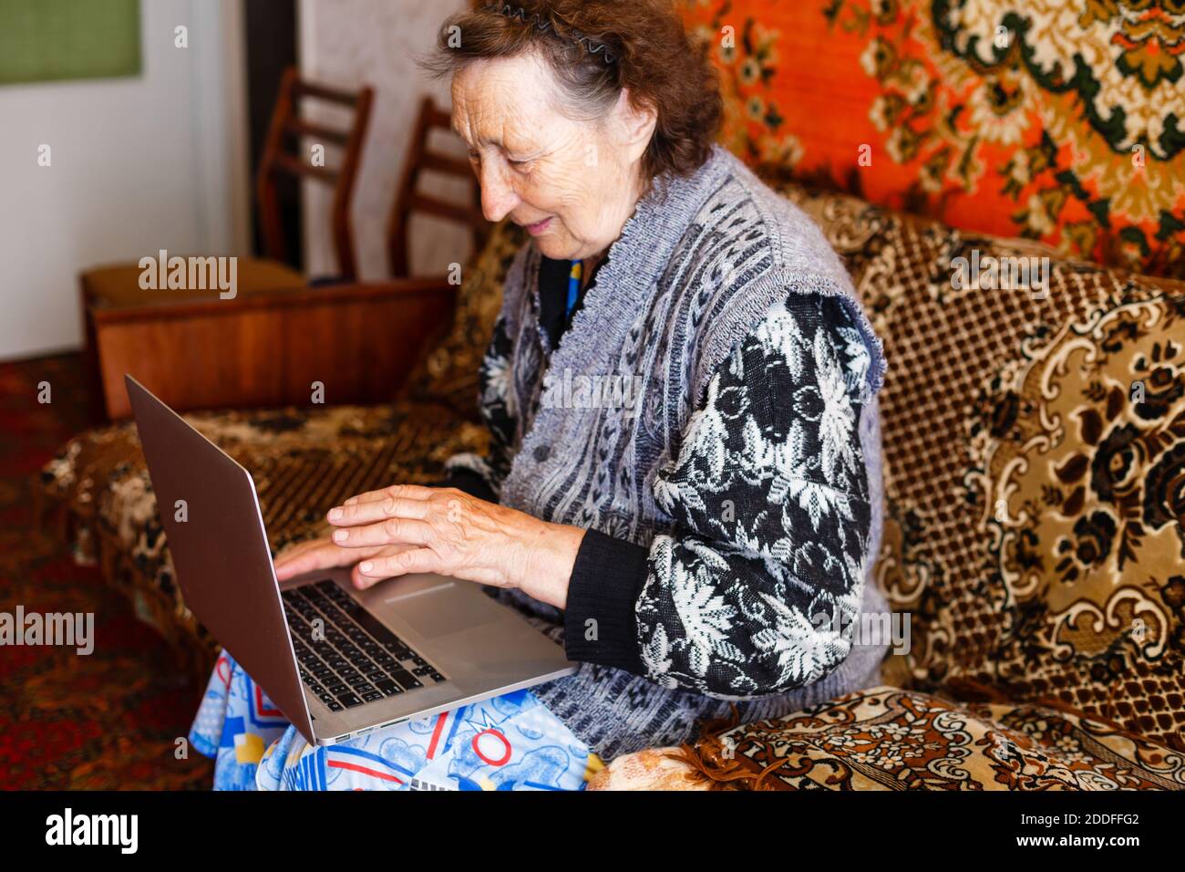 Elder woman using a laptop computer at home Stock Photo - Alamy