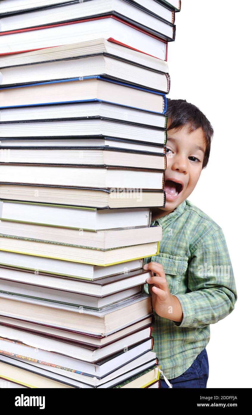 A big tower of many books vertical and kid hiding Stock Photo - Alamy