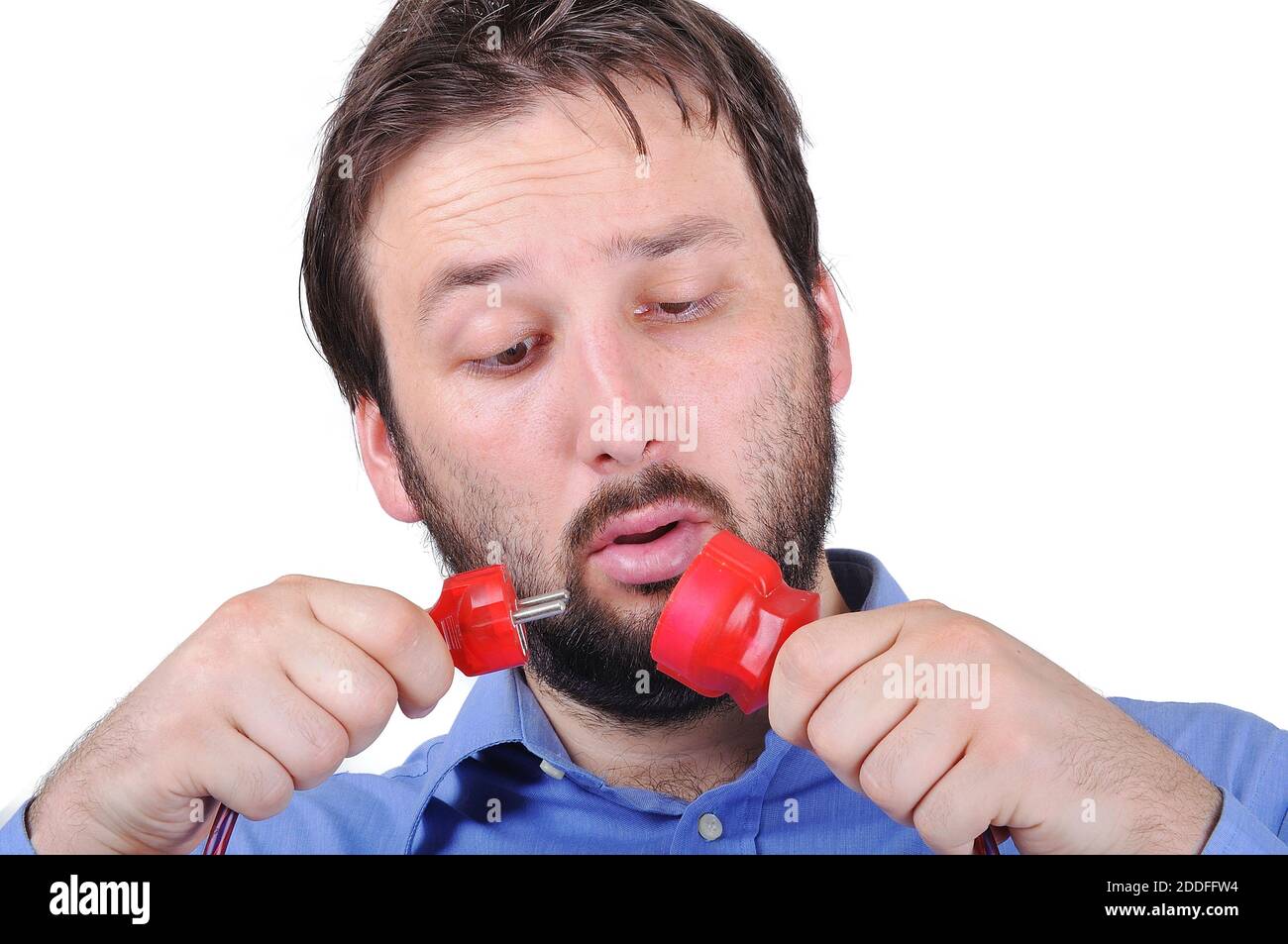 Young man with surprised face doing with electricity Stock Photo - Alamy