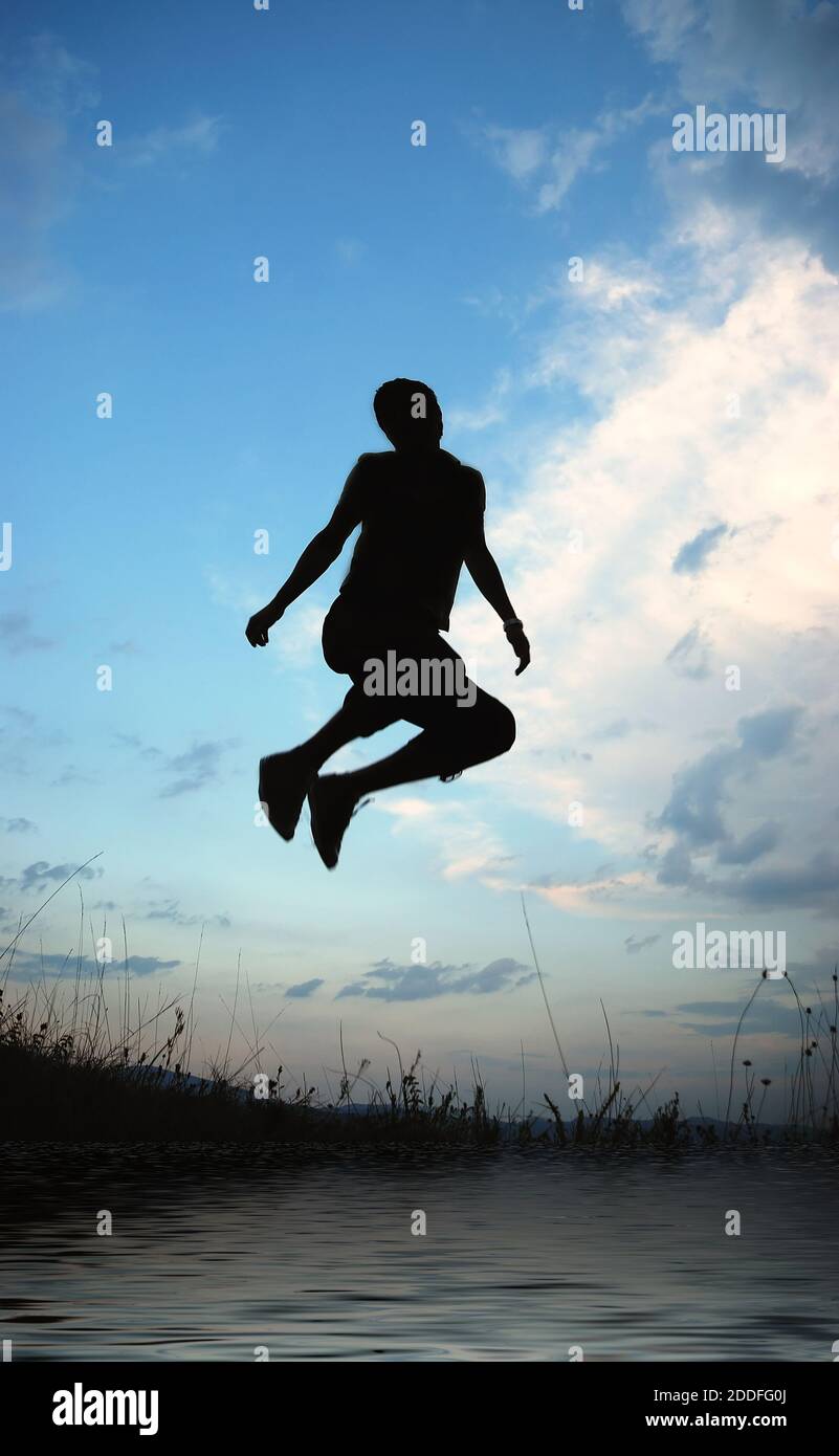 Young active man jumping, darkness Stock Photo - Alamy