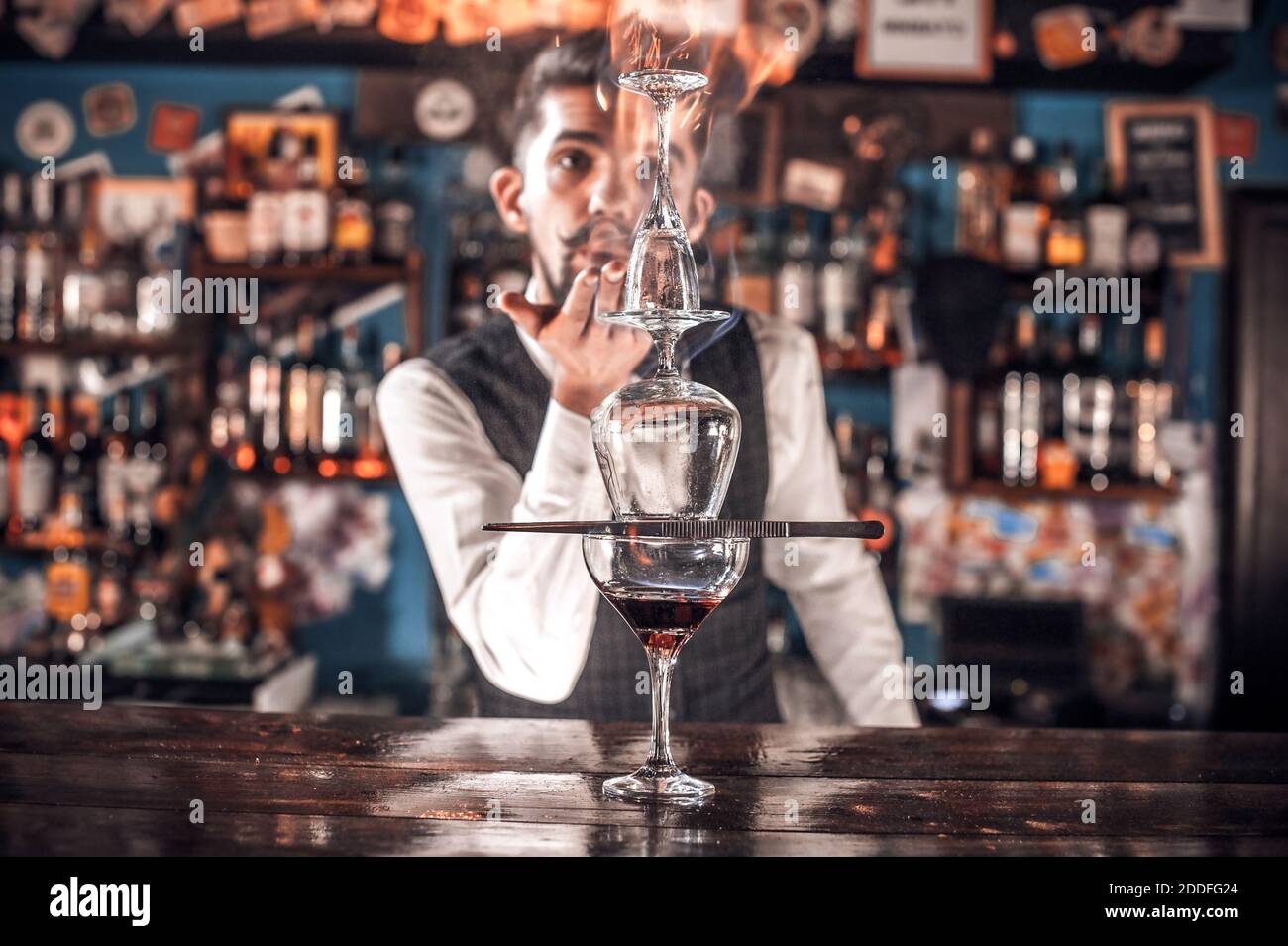 Bartender makes a cocktail in the saloon Stock Photo - Alamy