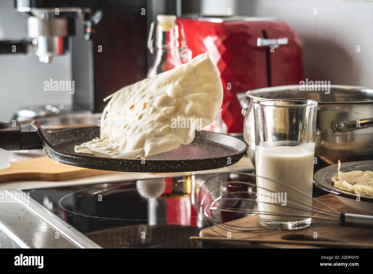 Person is flipping the pancake over by throwing it. Concept of making ...