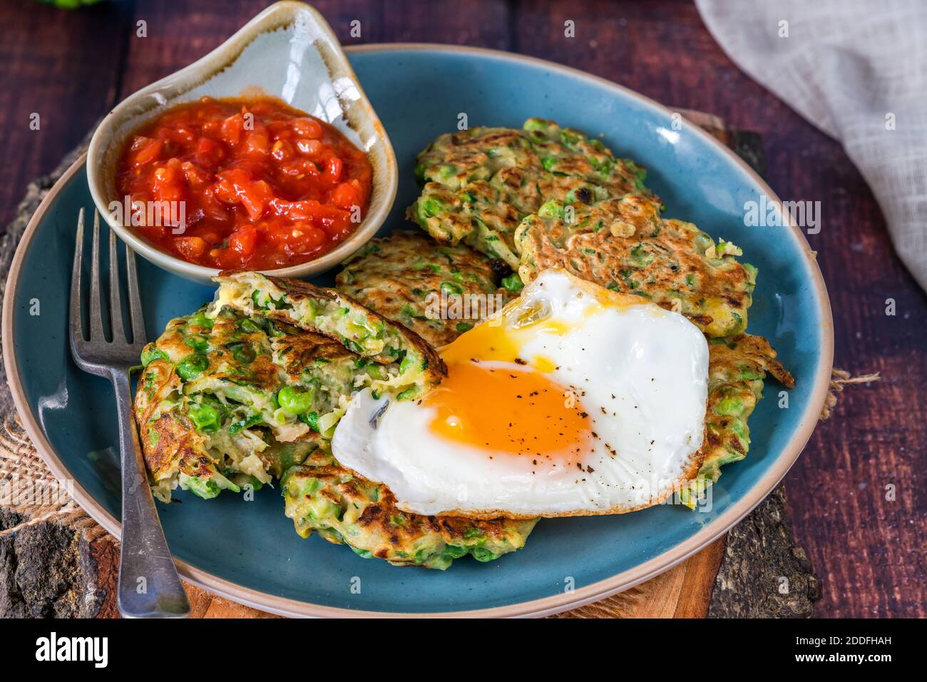 Courgette and green peas fritters with fried egg and tomato salsa ...